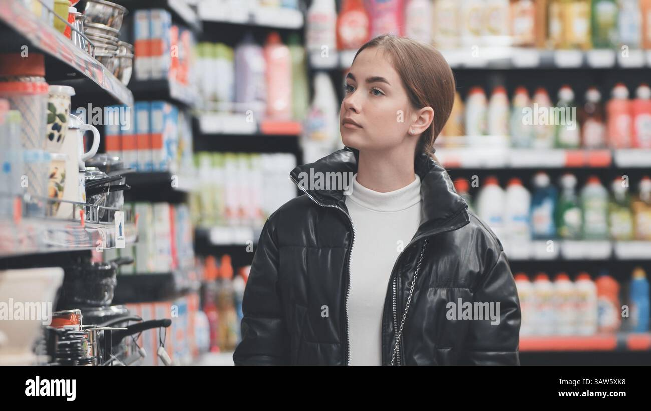 Shopper scanning shelves, comparing products, contemplating grocery ...
