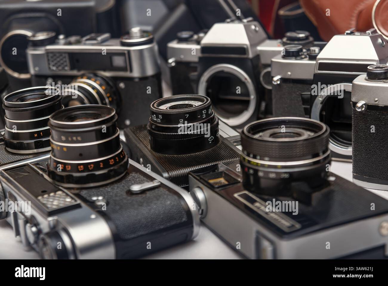 A diverse assortment of old film cameras displayed together ...