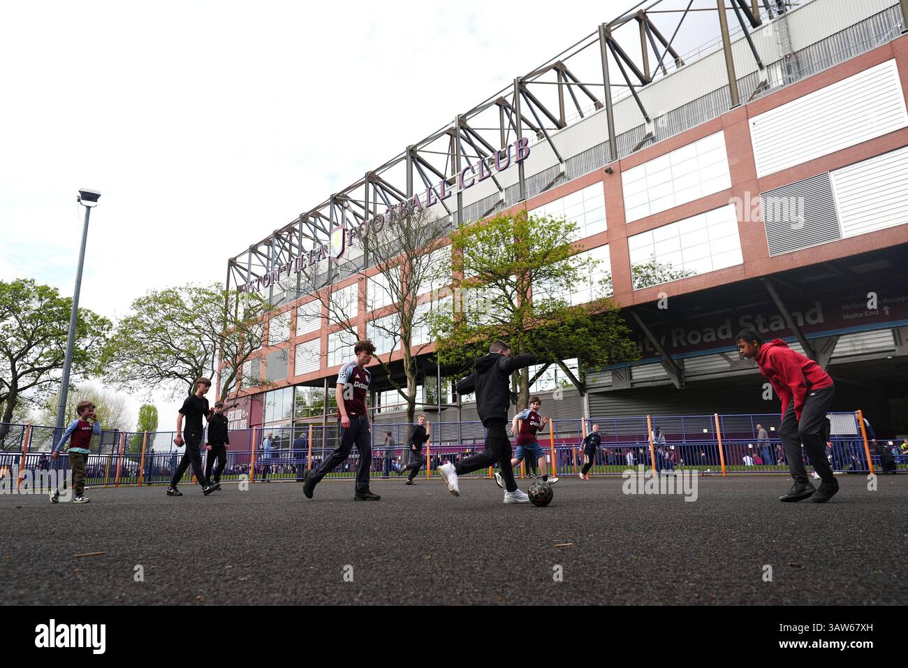 A general view of young fans playing football outside the ground ahead ...
