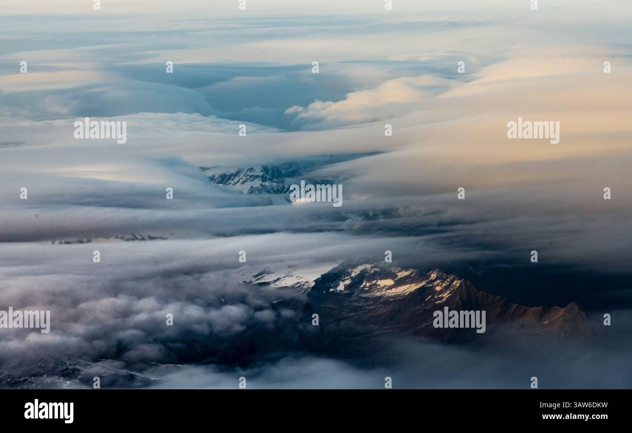 Aerial view of the French Alps beneath a veil of cloud en route from ...