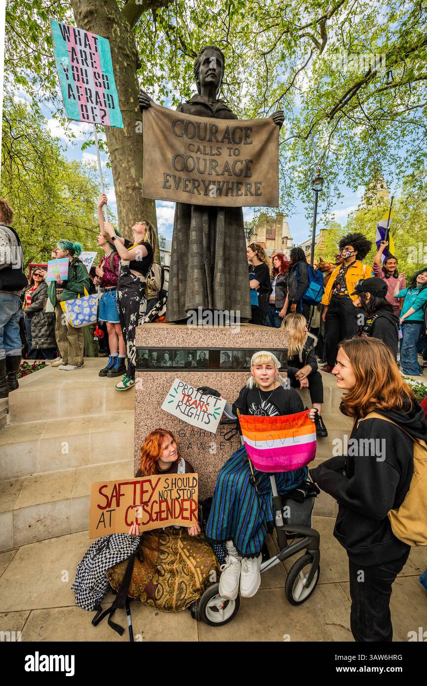 London, UK. 19th Apr, 2025. Gathering around the Suffragettes statue of ...