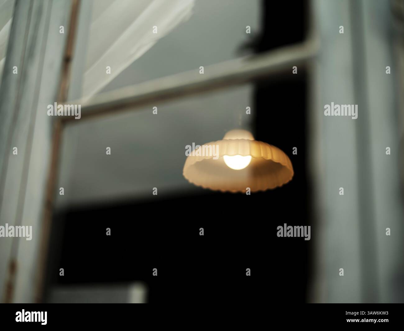 Warm Glow Pendant Lamp Through Window Frame in Minimalist Interior ...