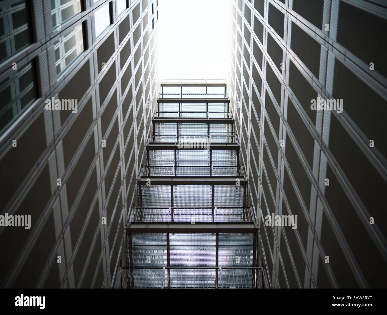 Suspended Metal Catwalks in Symmetrical Urban Lightwell Stock Photo - Alamy