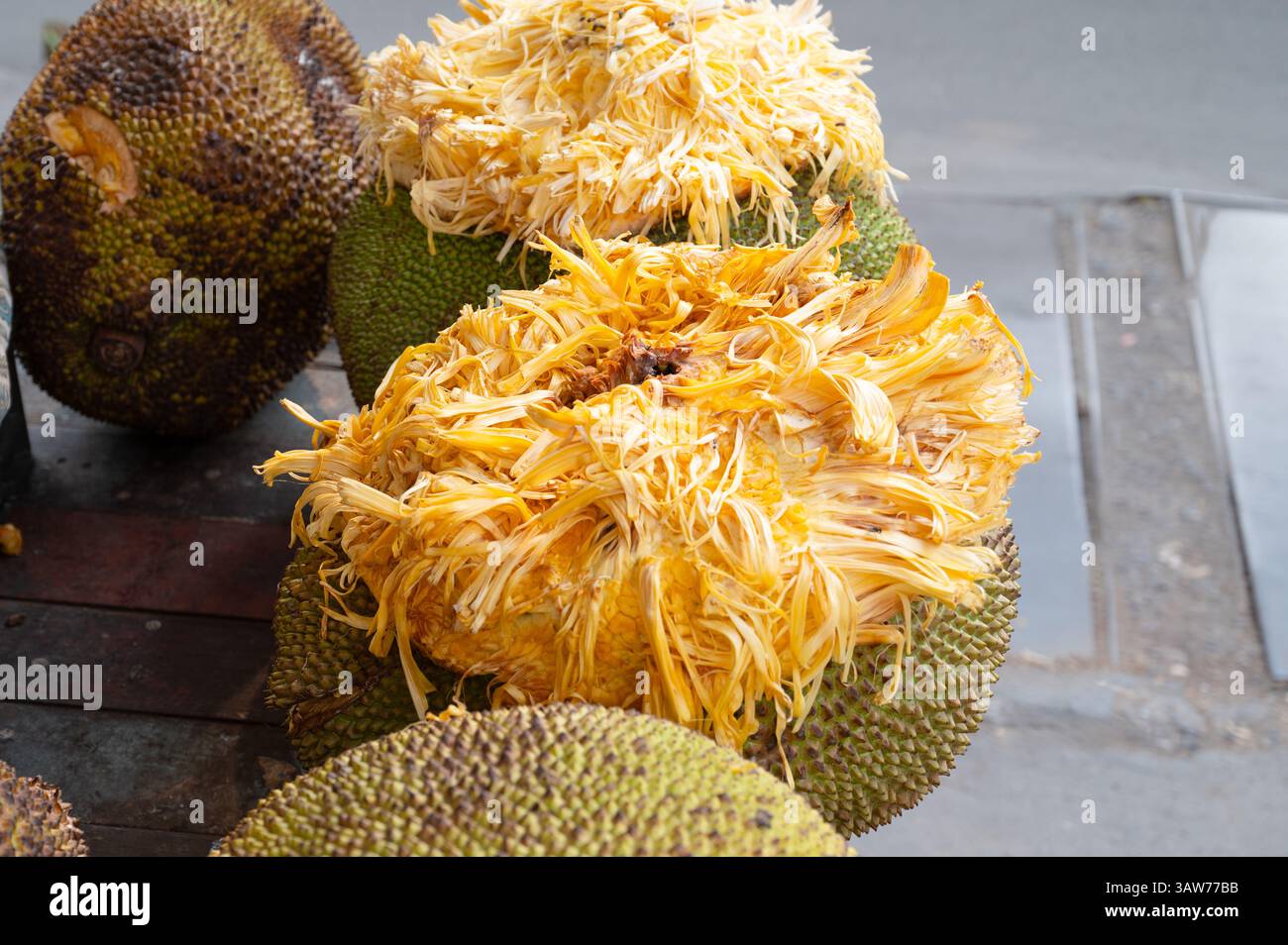 Ripe jackfruit or nangka with fleshy petals on a market stall in India ...