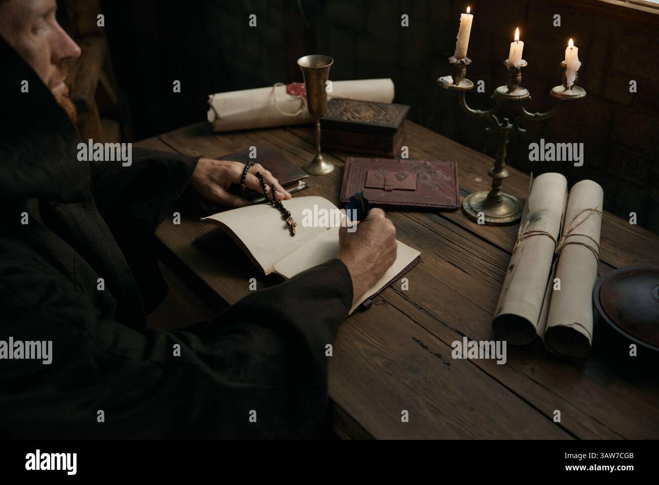 Crop shot of medieval monk chronicler writing ancient manuscript under candlelight Stock Photo ...