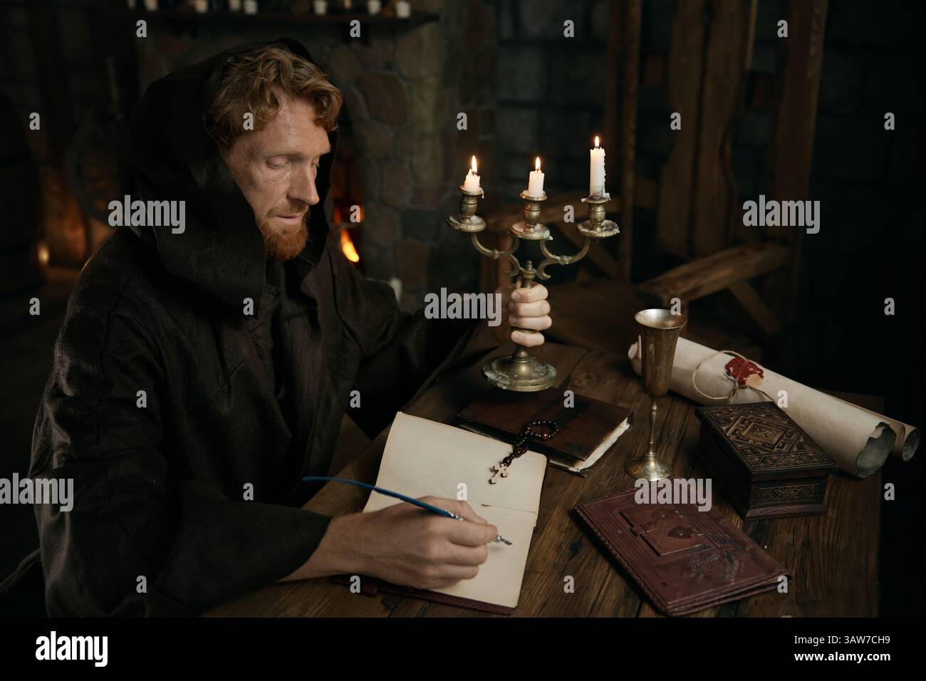 Medieval monk chronicler writing ancient manuscript under candlelight ...