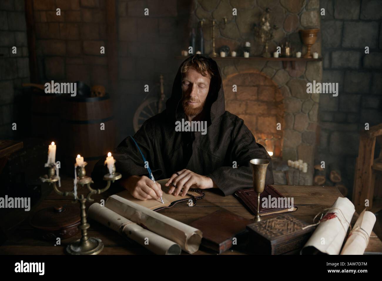 Portrait of medieval monk writing historic manuscripts at table Stock ...