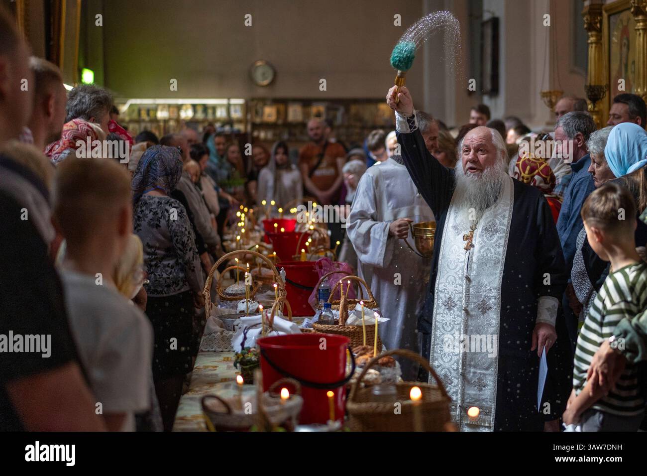 A Lithuanian Orthodox priest blesses cakes and Easter eggs during an ...