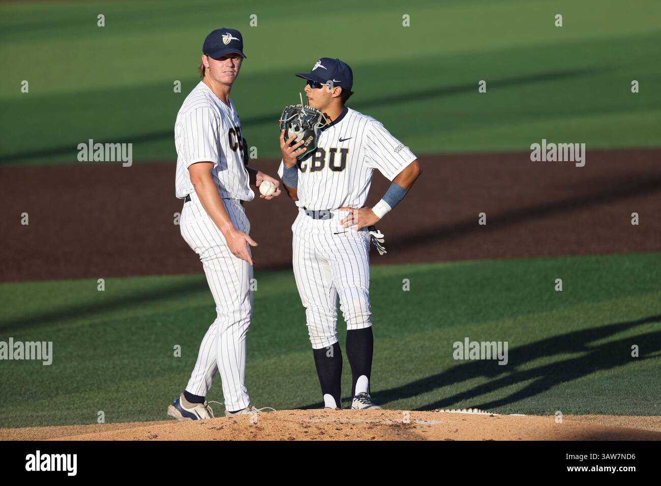 Pitcher Cody New (21) of the Cal Baptist Lancers talks to teammate ...
