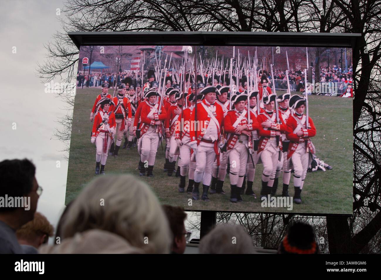 Lexington, USA. 19th Apr, 2025. Spectators watch a reenactment at the ...