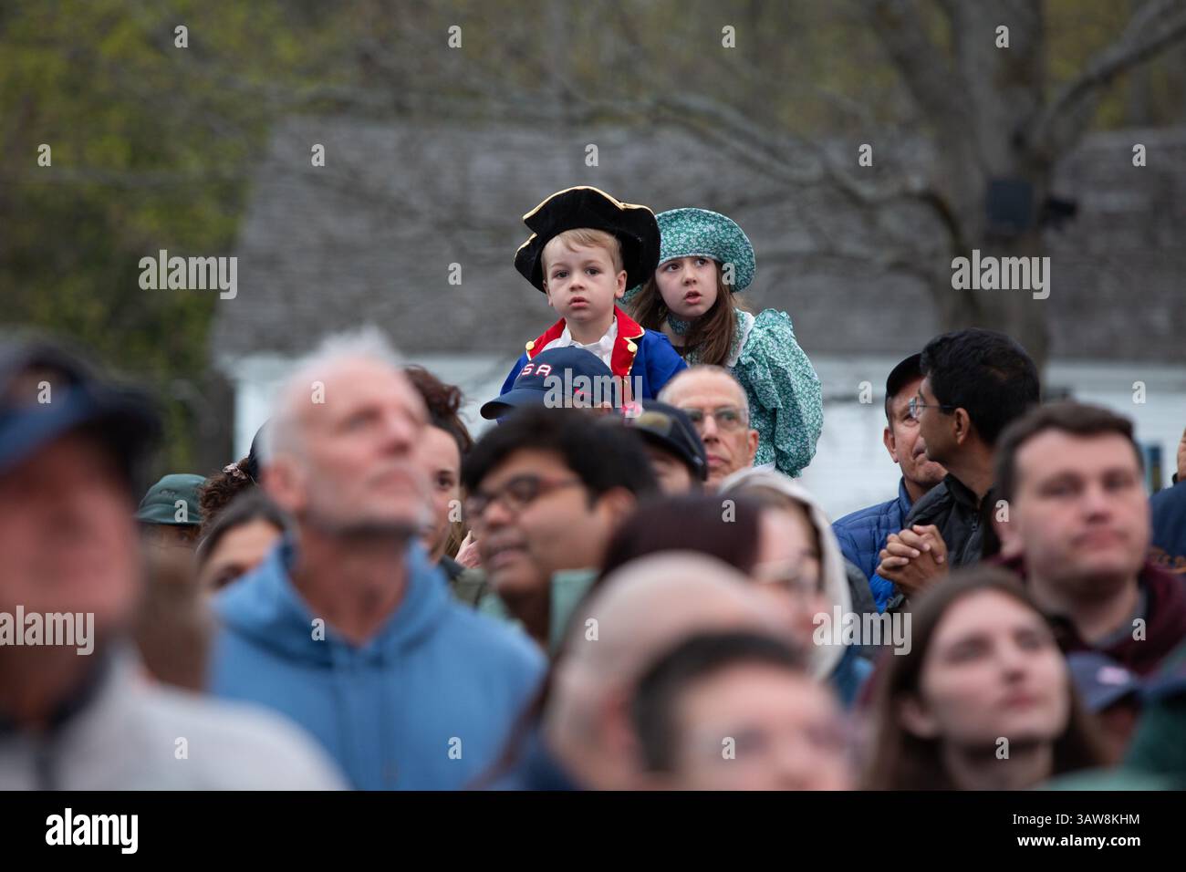 Lexington, USA. 19th Apr, 2025. Spectators watch a reenactment at the ...