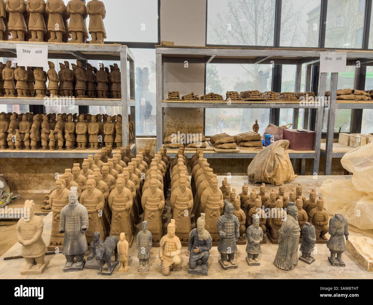 Terracota warriors, Clay figurines at various stages of production at a ...