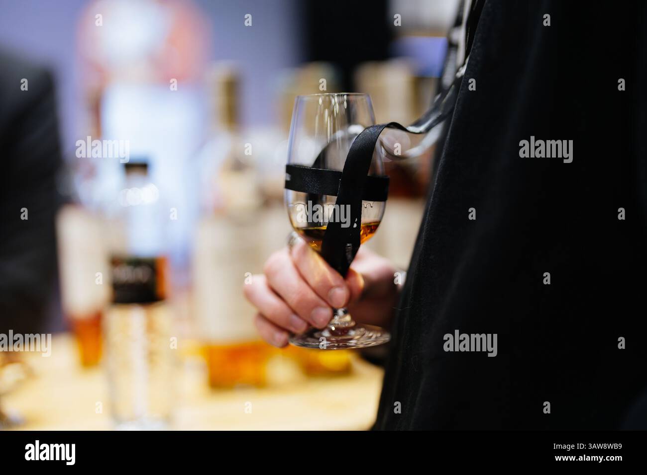 Elegant glass holding whiskey at a sophisticated tasting event Stock ...