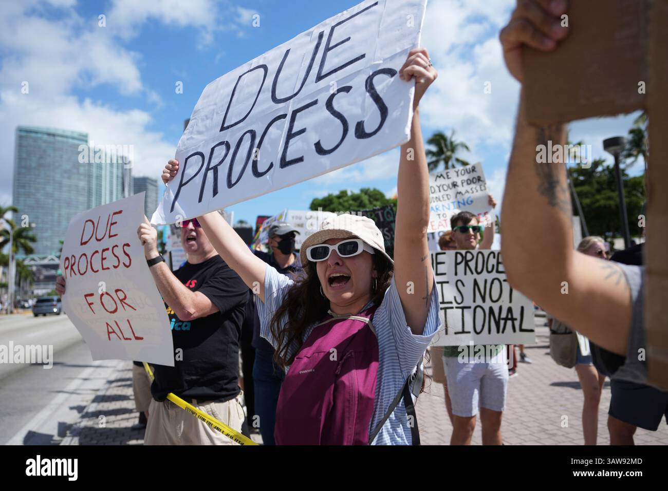 People hold signs and chant slogans during a protest against the Trump ...