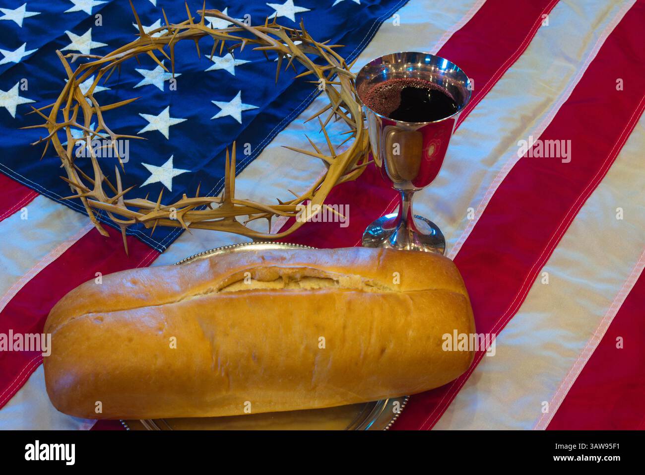 Christian communion elements of bread and wine sit with a crown of ...