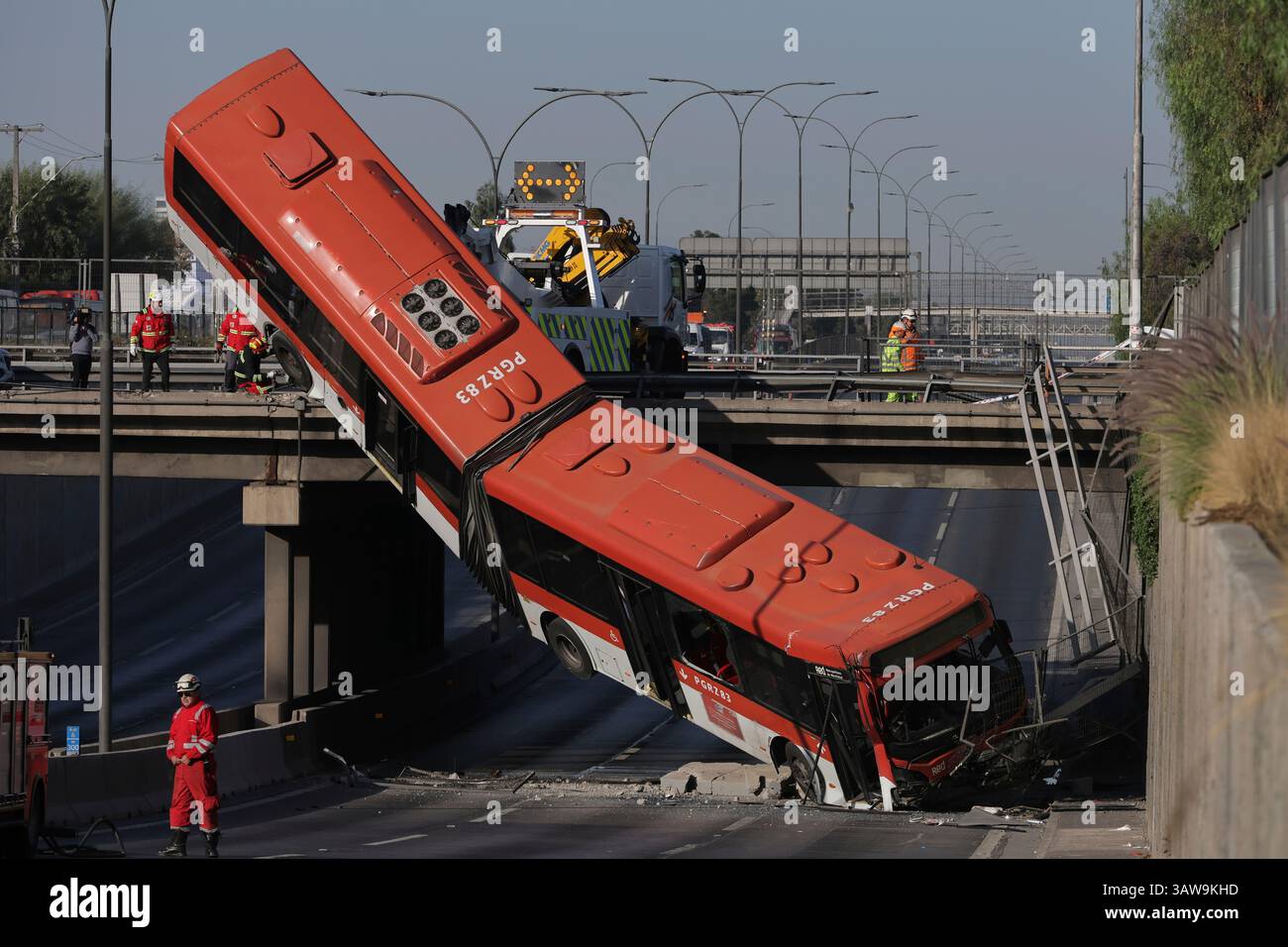 A bus hangs off an overpass after colliding with a vehicle, in Santiago ...