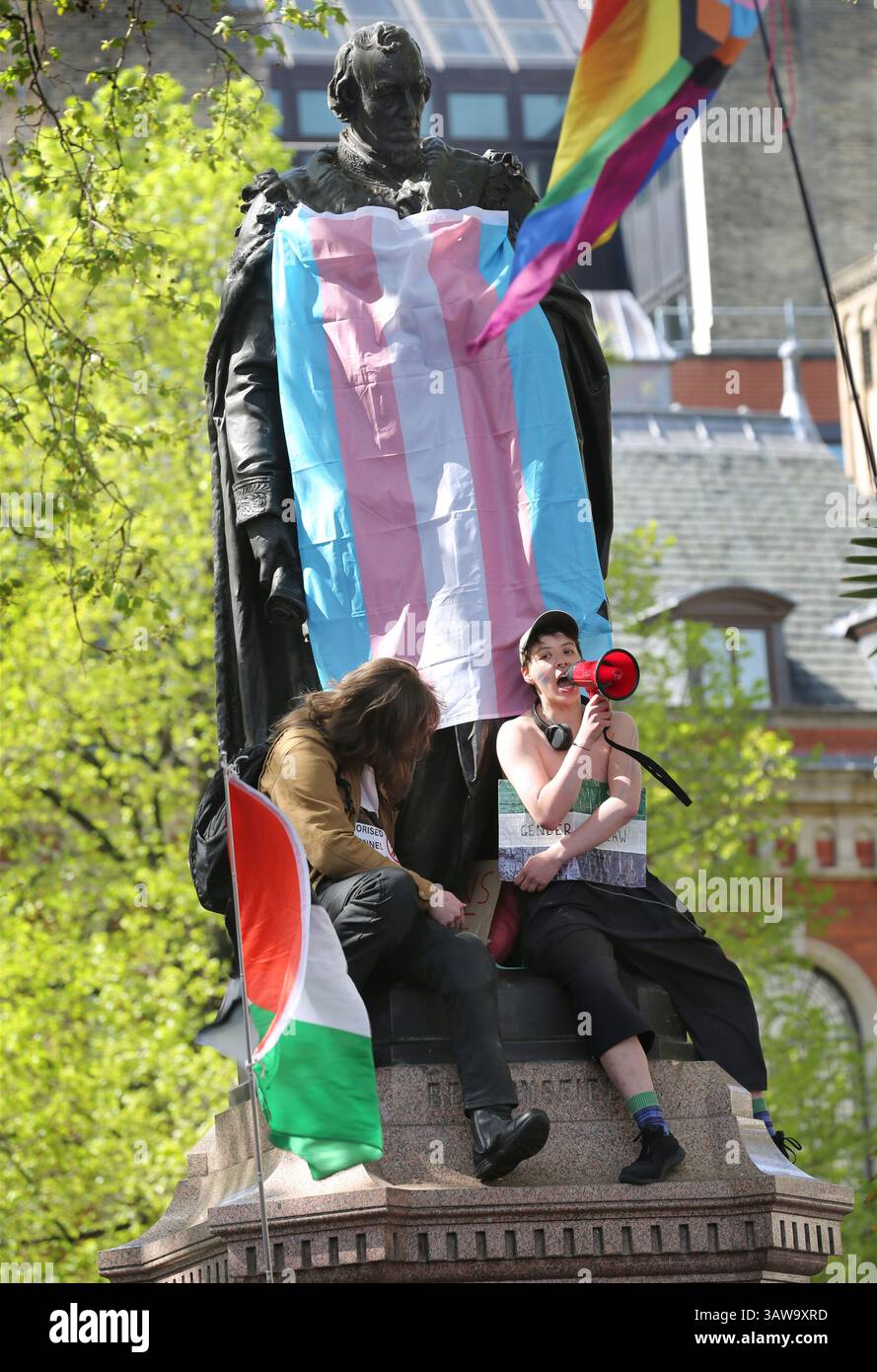 London, England, UK. 19th Apr, 2025. Supporters of trans rights sit on ...
