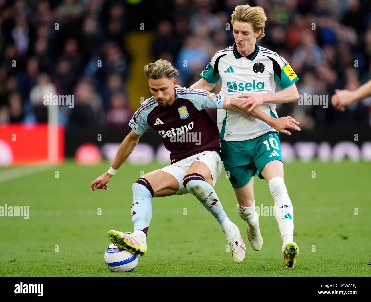 Aston Villa's Matty Cash (left) and Newcastle United's Anthony Gordon ...