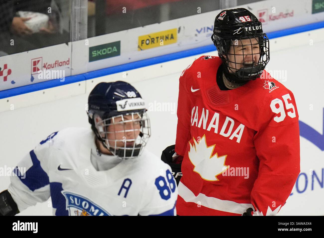 Finland's Ronja Savolainen, left, skates past as Daryl Watts of Canada ...