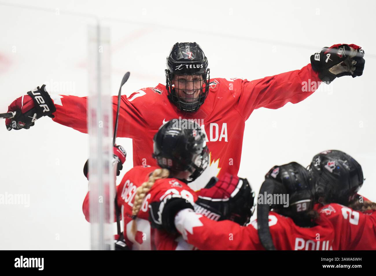Daryl Watts of Canada, down, celebrates with teammates after scoring ...