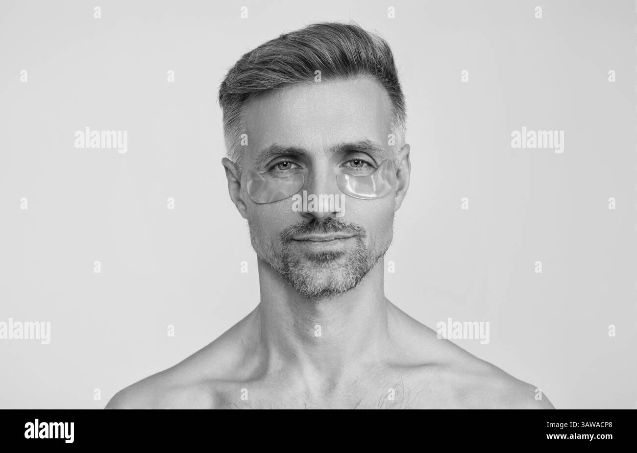 Beauty man face with under eye collagen pads. Mature man has fresh ...