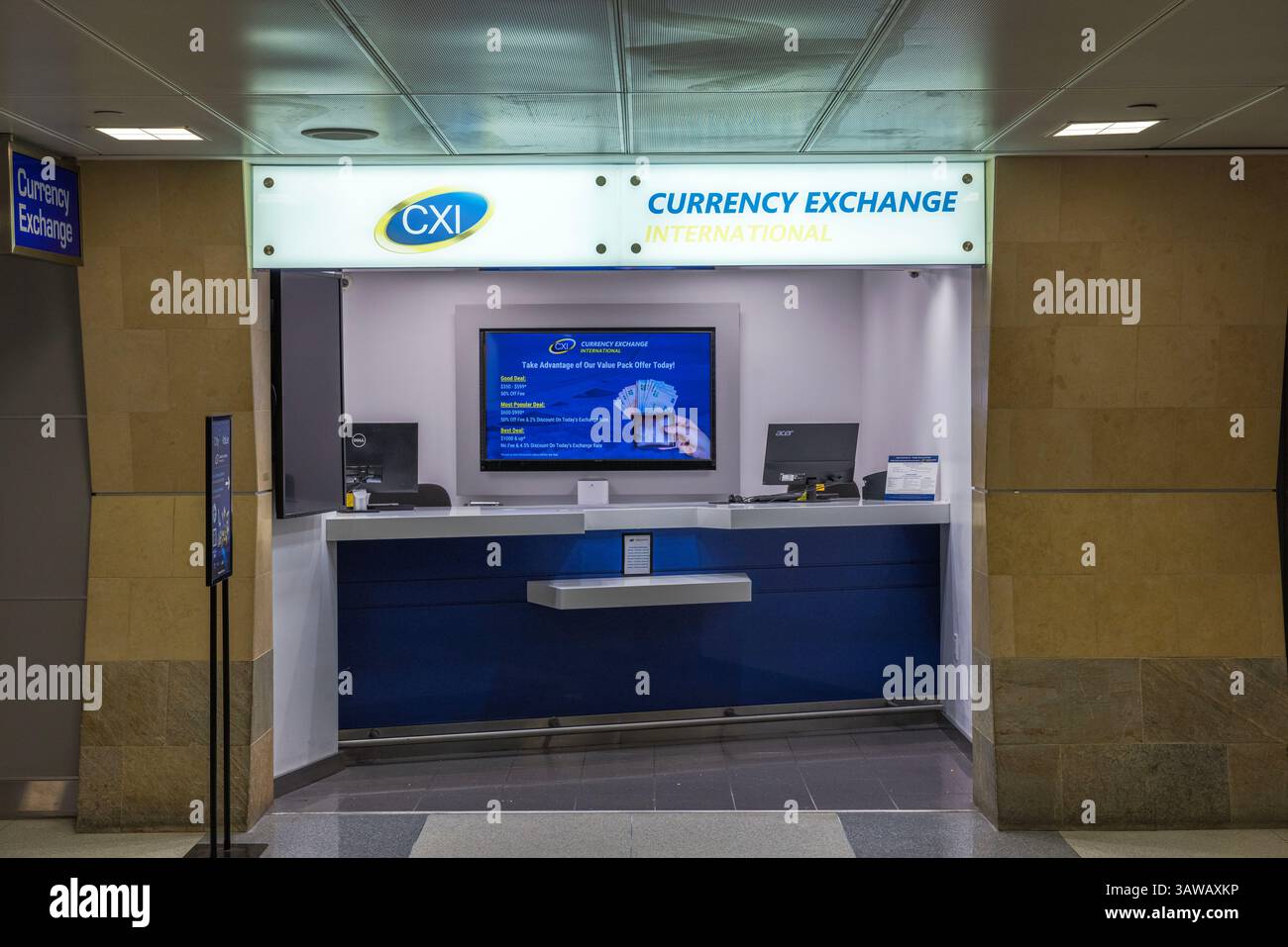Currency exchange counter with digital display and computers at JFK ...