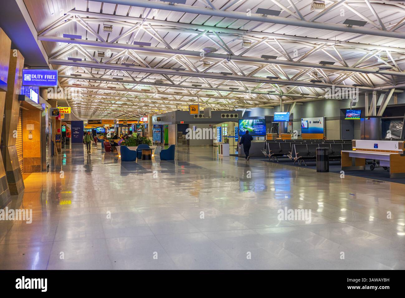 Wide interior view of JFK terminal with seating area, duty free shop ...