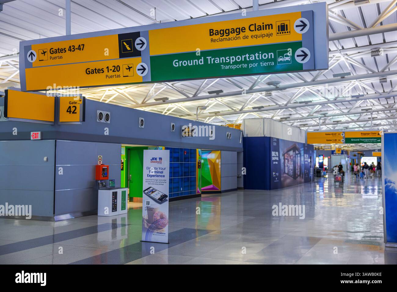 Terminal interior at JFK airport with baggage claim signs, gate numbers ...