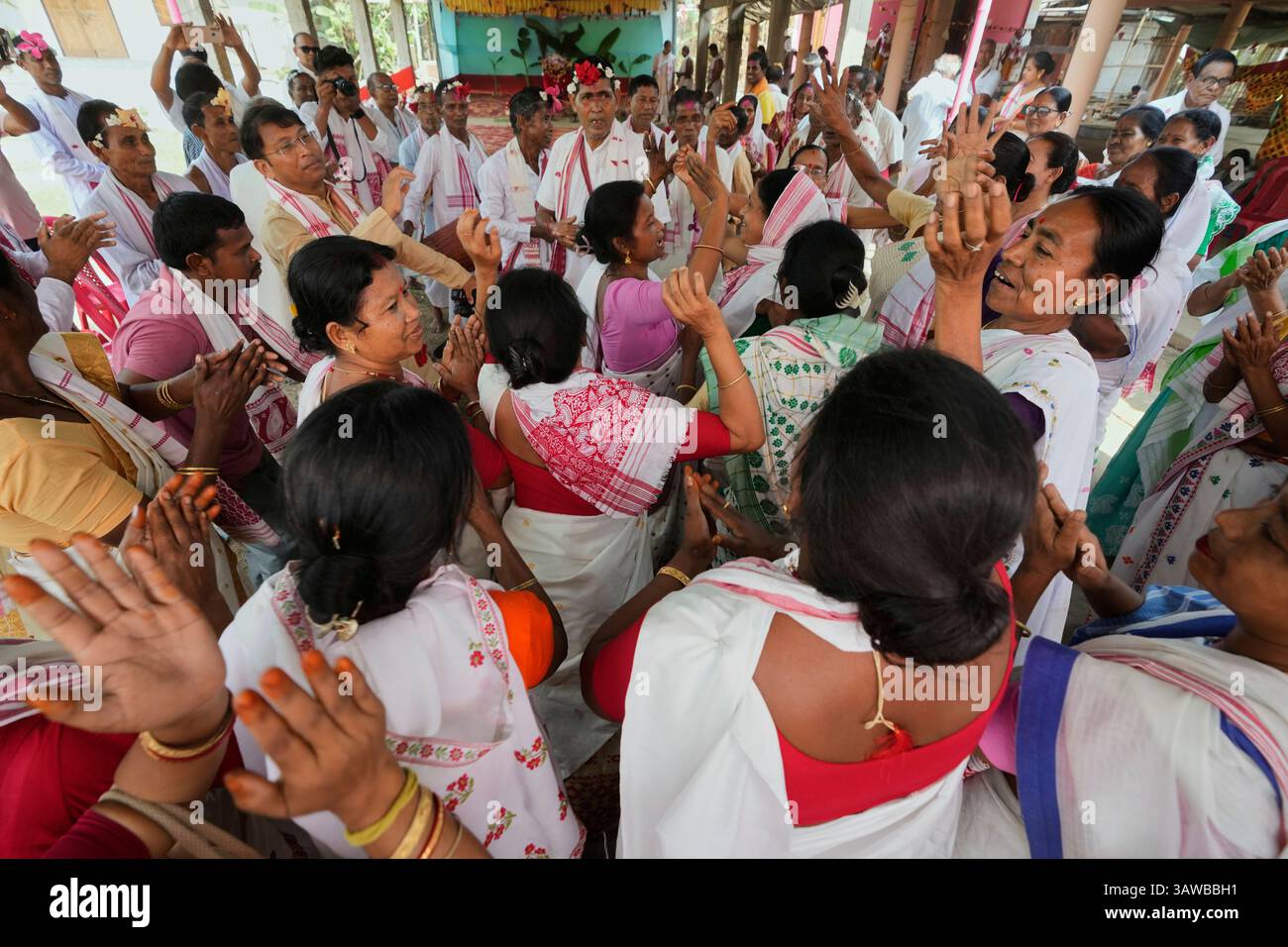 Villagers with traditional Assamese attire perform a ritual to welcome ...