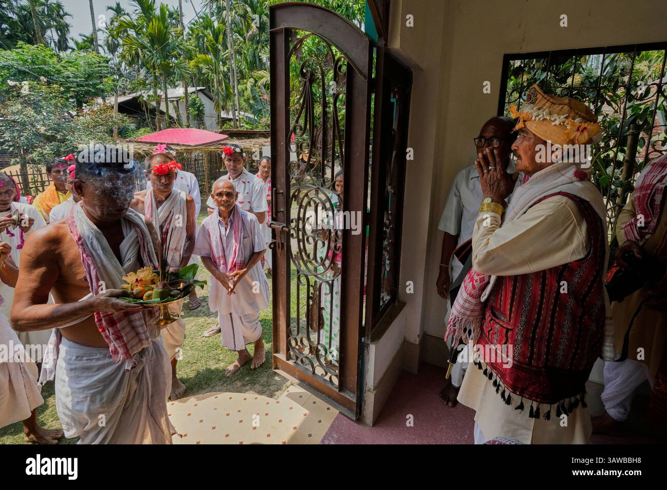 Villagers with traditional Assamese attire welcome a villager, right ...