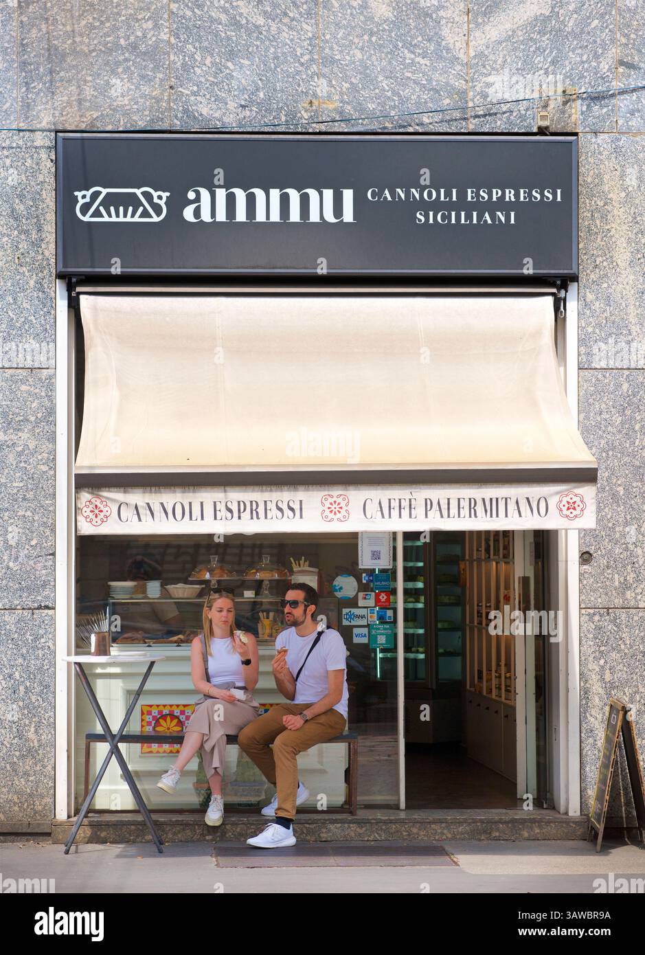 Couple enjoying a snack at an Ammu Cannoli Espressi Siciliani cafe in ...