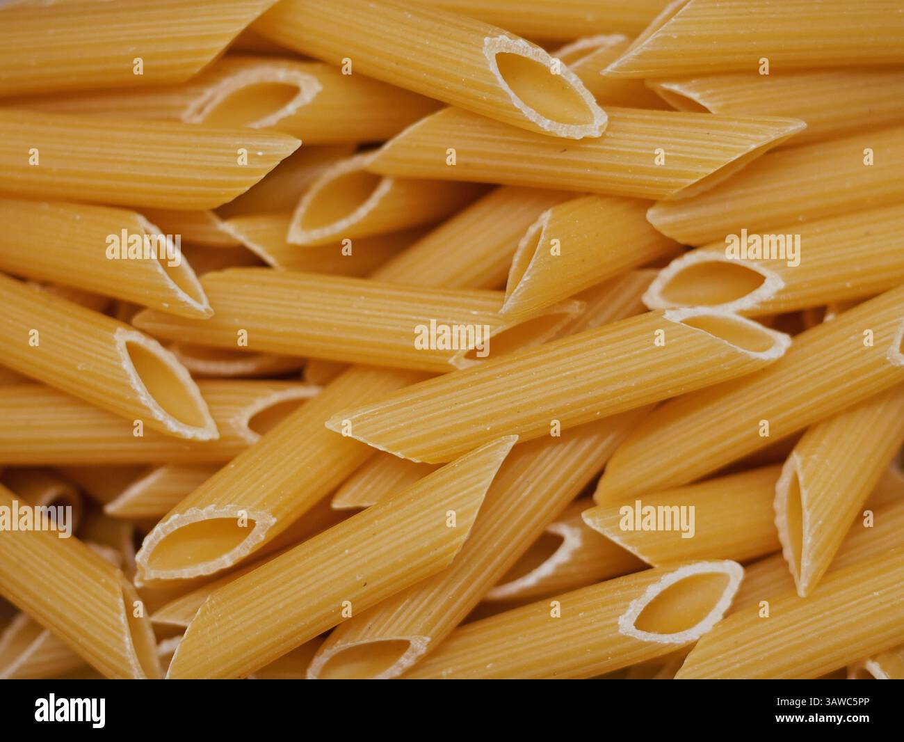 Raw whole dry penne rigate hi-res stock photography and images - Alamy