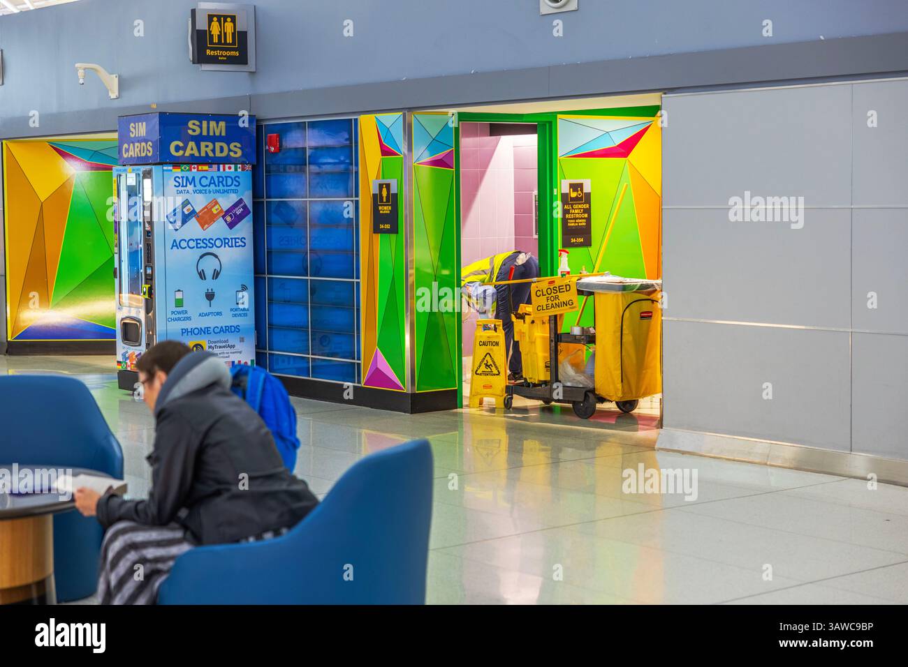 Airport restroom under cleaning near SIM card kiosk at JFK terminal ...