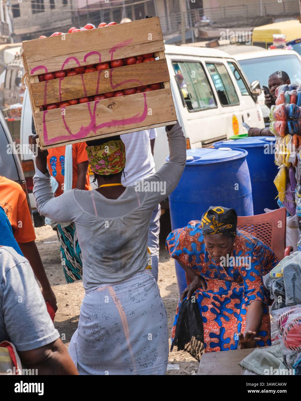 Kumasi, Ghana. Kejetia Market, Woman Carrying Box of Tomatoes on her ...