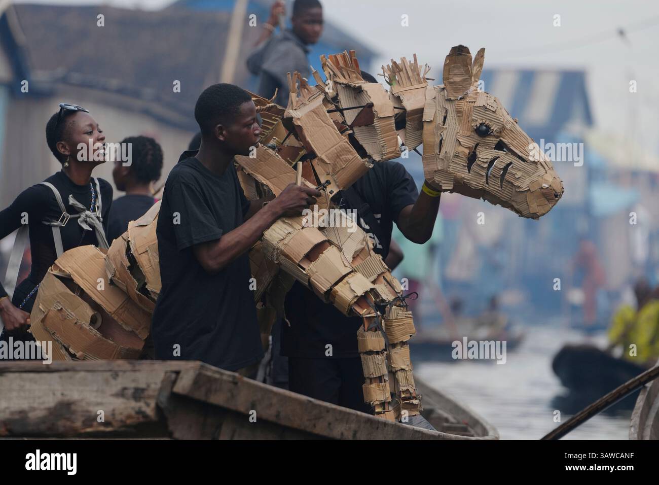 Puppeteers move cardboard animals in canoes at the Makoko Slum in Lagos ...