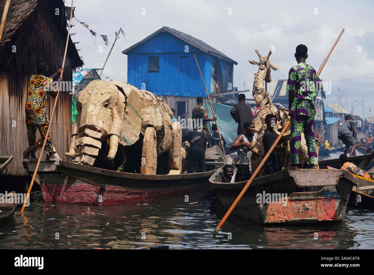 Puppeteers move cardboard animals in canoes at the Makoko Slum in Lagos ...