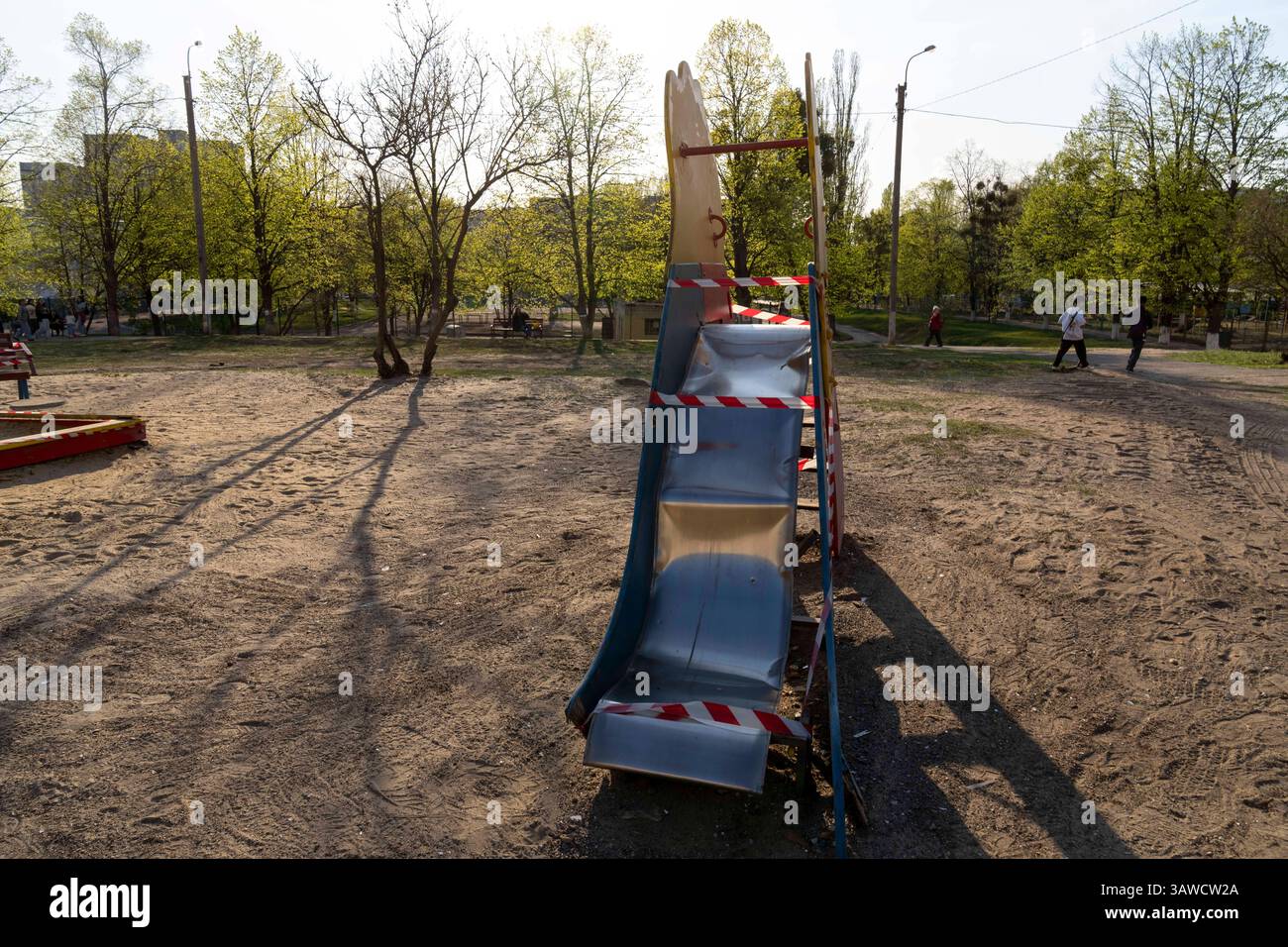 Damaged playground slide in front of a residential building in Kharkiv ...