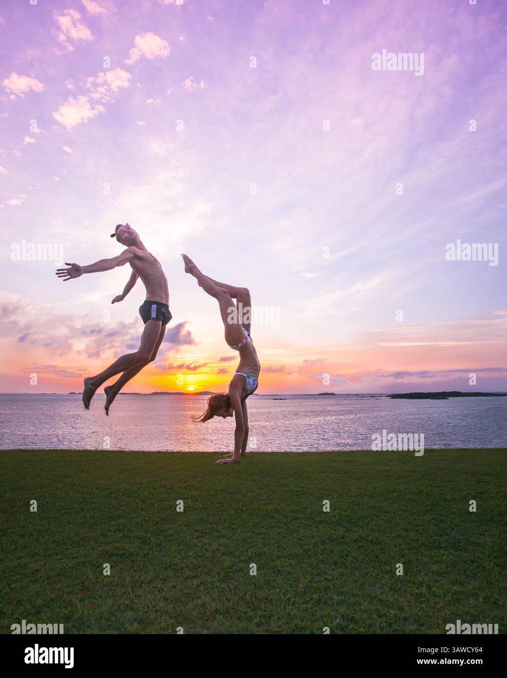 Sporty couple man and woman silhouettes doing an acrobatic yoga poses ...
