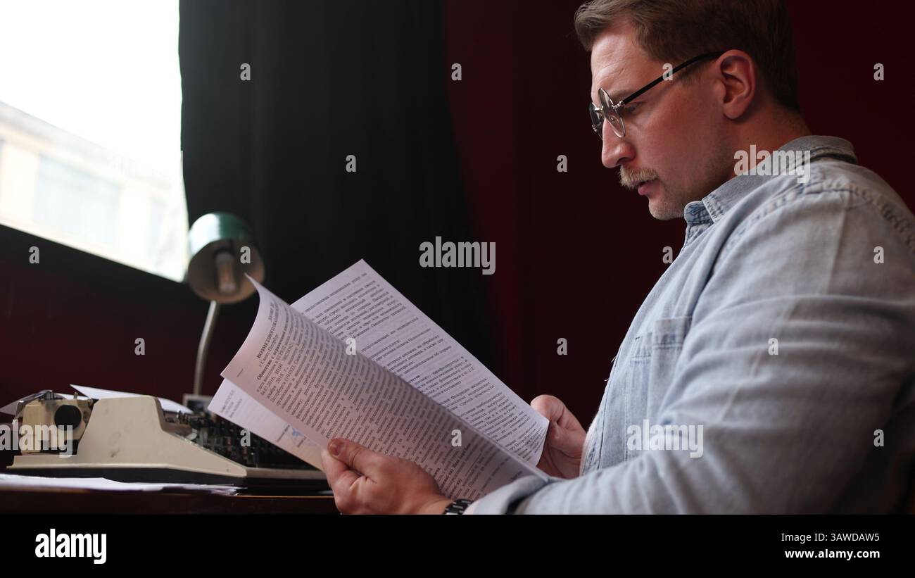Thoughtful male writer at vintage desk, cinematic soft-focus on ...