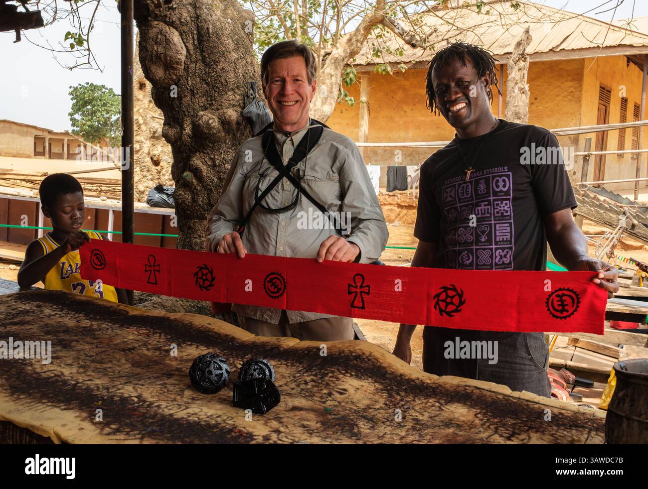 Ghana, Asonomaso. Ntonso Adinkra Village. Tourist with Cloth he has ...