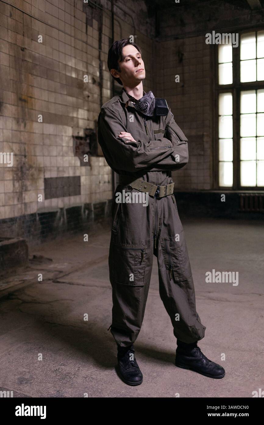 Military-clad man in gas mask, grunge portrait with tactical gear in ...