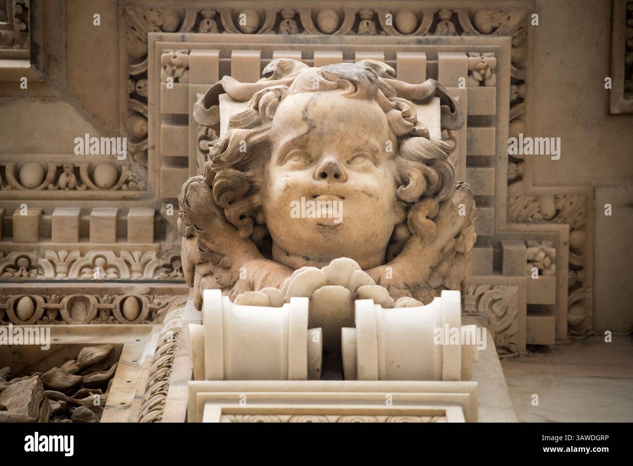 Stone carved cherub, part of the intricate ornamentation of Milan ...
