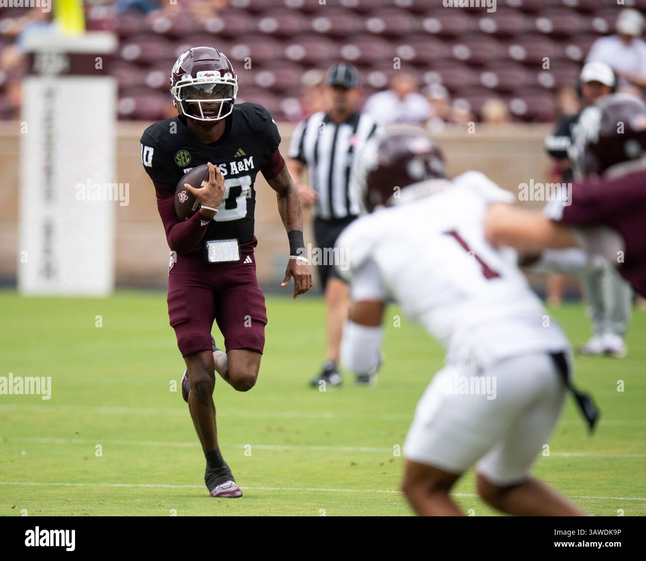 Texas A&M quarterback Marcel Reed, left, runs the ball during the team ...