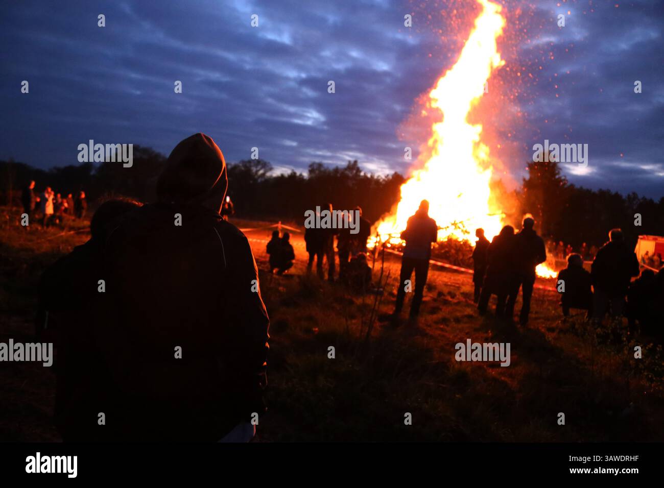 Cottbus, Brandenburg, Germany. 19th Apr, 2025. Visitors look to the Easter fire at Branitzer ...