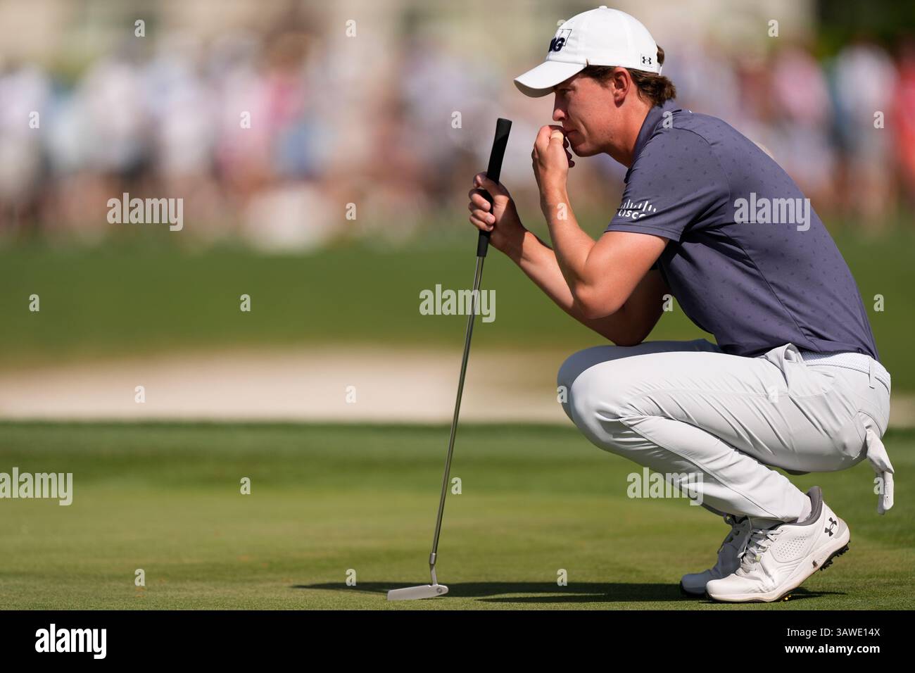 Maverick McNealy lines up a putt on the 16th green during the third ...