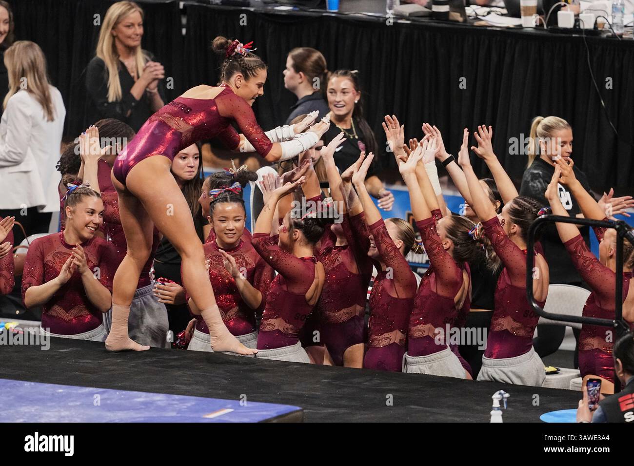 Oklahoma's Jordan Bowers, top, celebrates with her team after competing ...