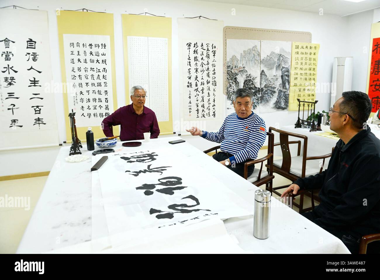 RIZHAO, CHINA - APRIL 19, 2025 - Elderly people exchange calligraphy ...