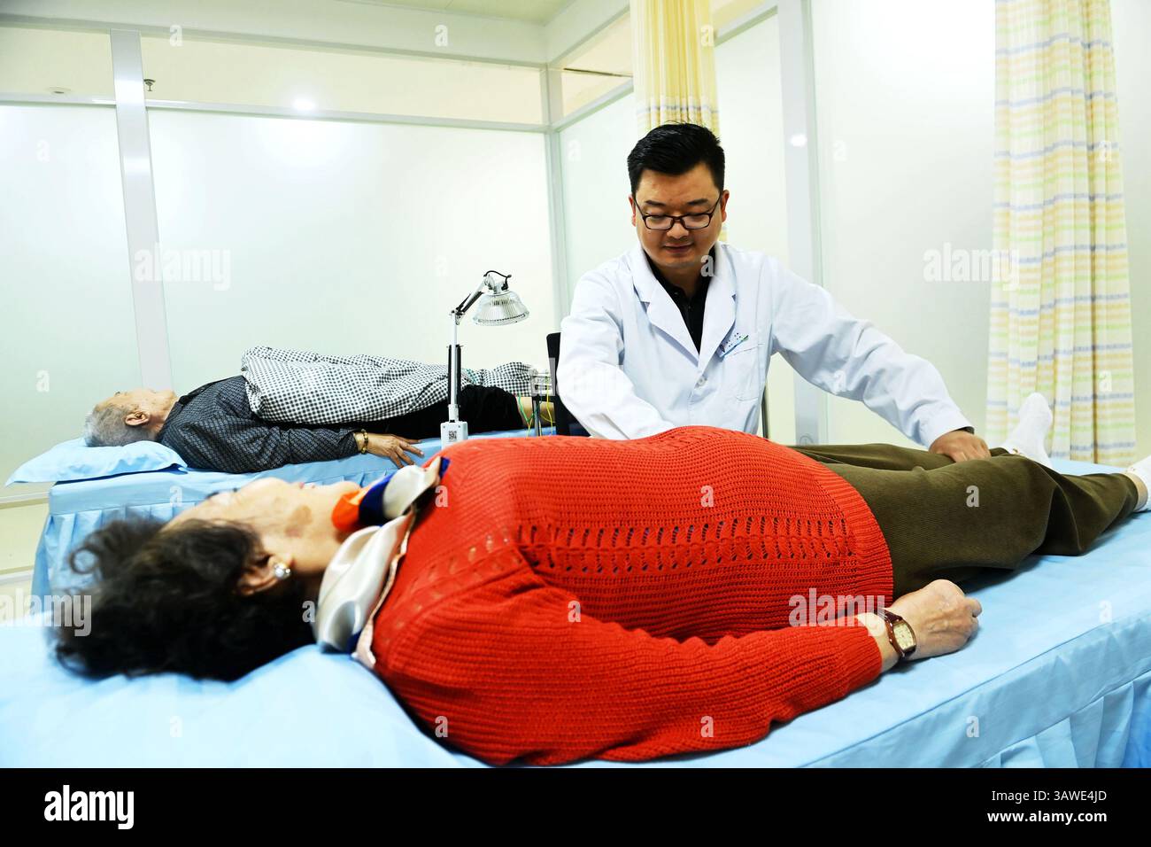 RIZHAO, CHINA - APRIL 19, 2025 - A medical staff member is providing ...
