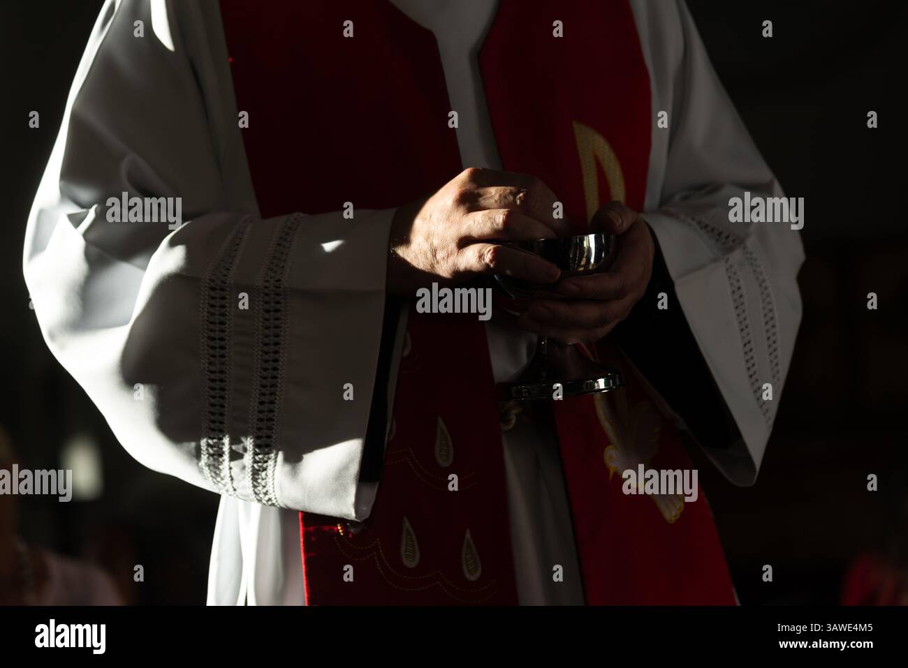 Salvador, Bahia, Brazil - April 18, 2025: A priest is seen offering the ...