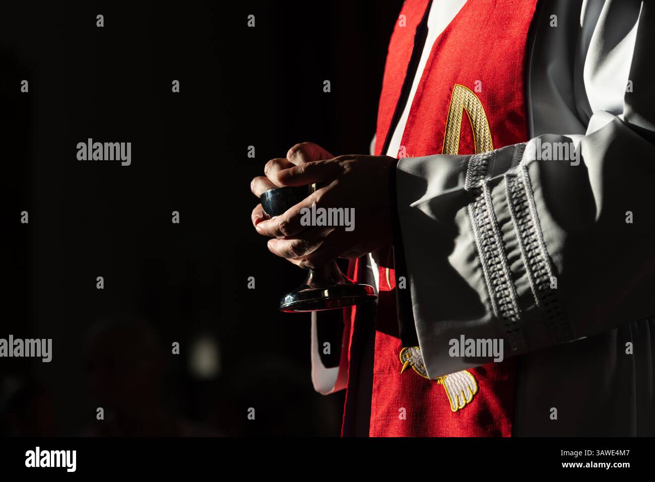 Salvador, Bahia, Brazil - April 18, 2025: A priest is seen offering the ...
